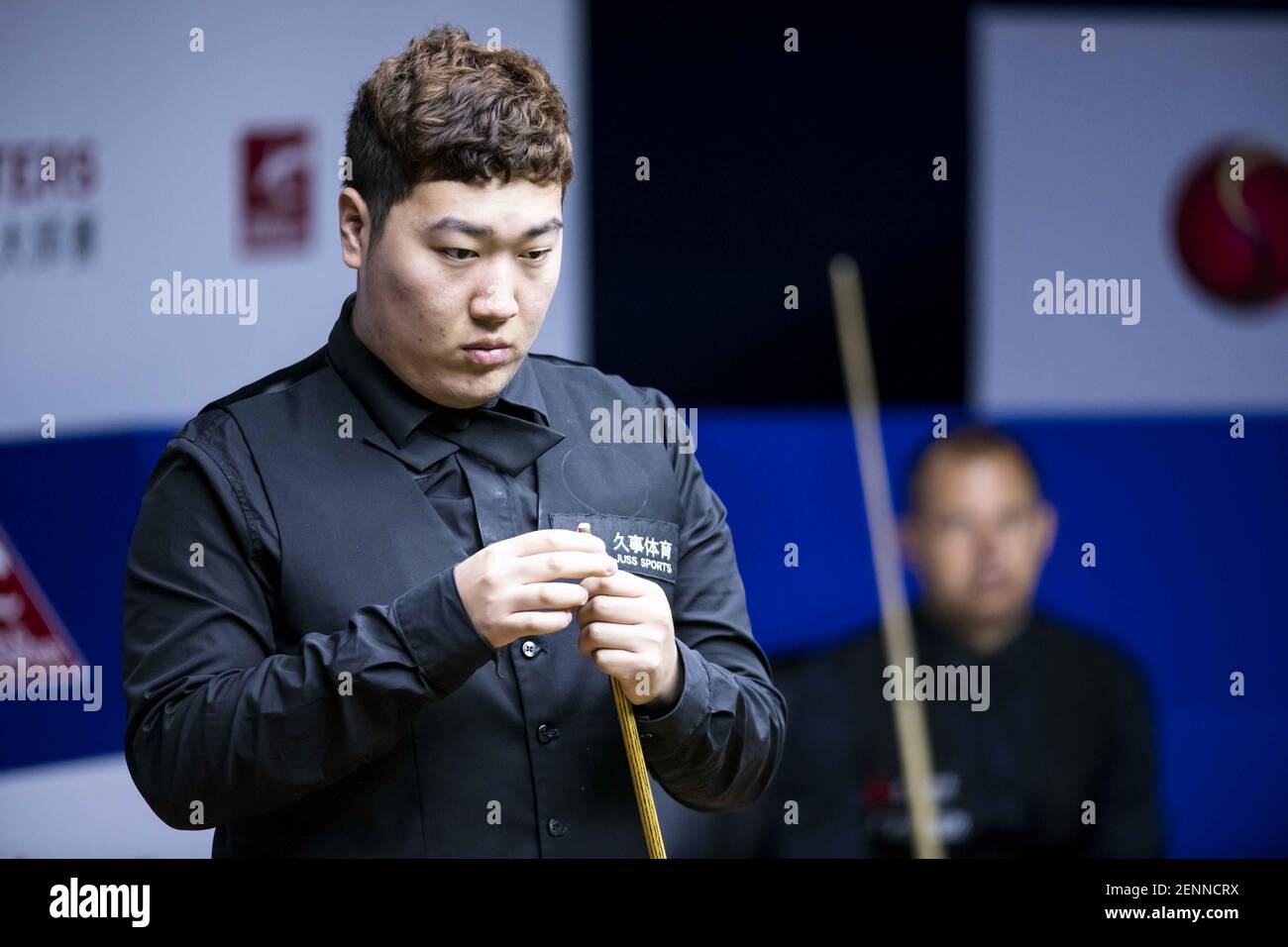 Chinese professional snooker player Yan Bintao polishes his pole at the ...