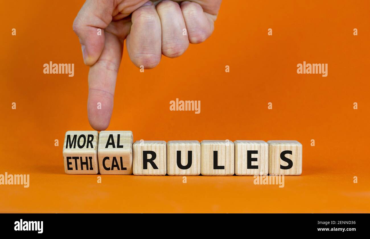 Ethical or moral rules symbol. Businessman turns wooden cubes and ...