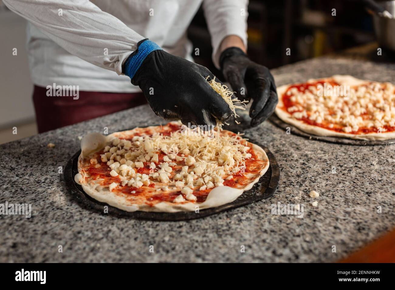 man cook prepares a pizza in a italian restaurant pizzeria Stock Photo ...