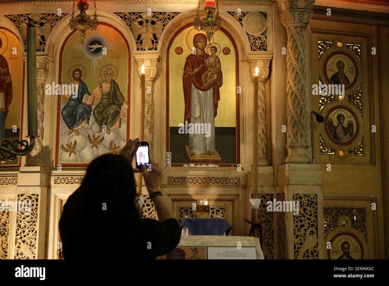 People flock to the painting of the Virgin Mary and take photos of what ...