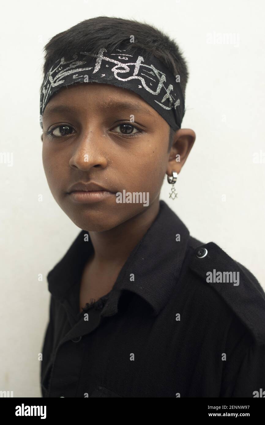 A Shia Muslim boy posses for a photo during the Ashura day in Dhaka ...