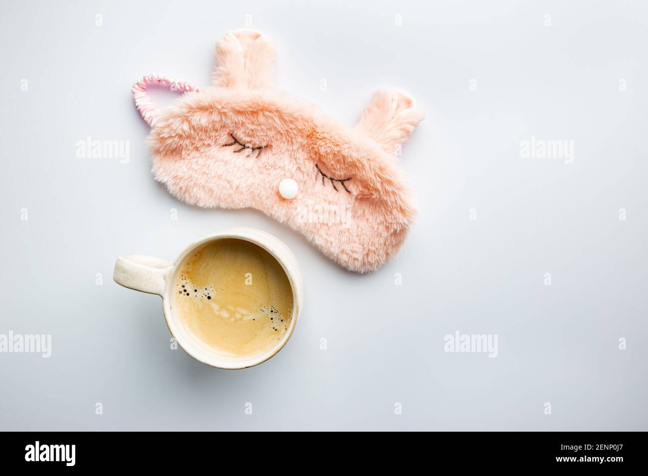 sleeping mask and coffee cup on white background. The concept of ...
