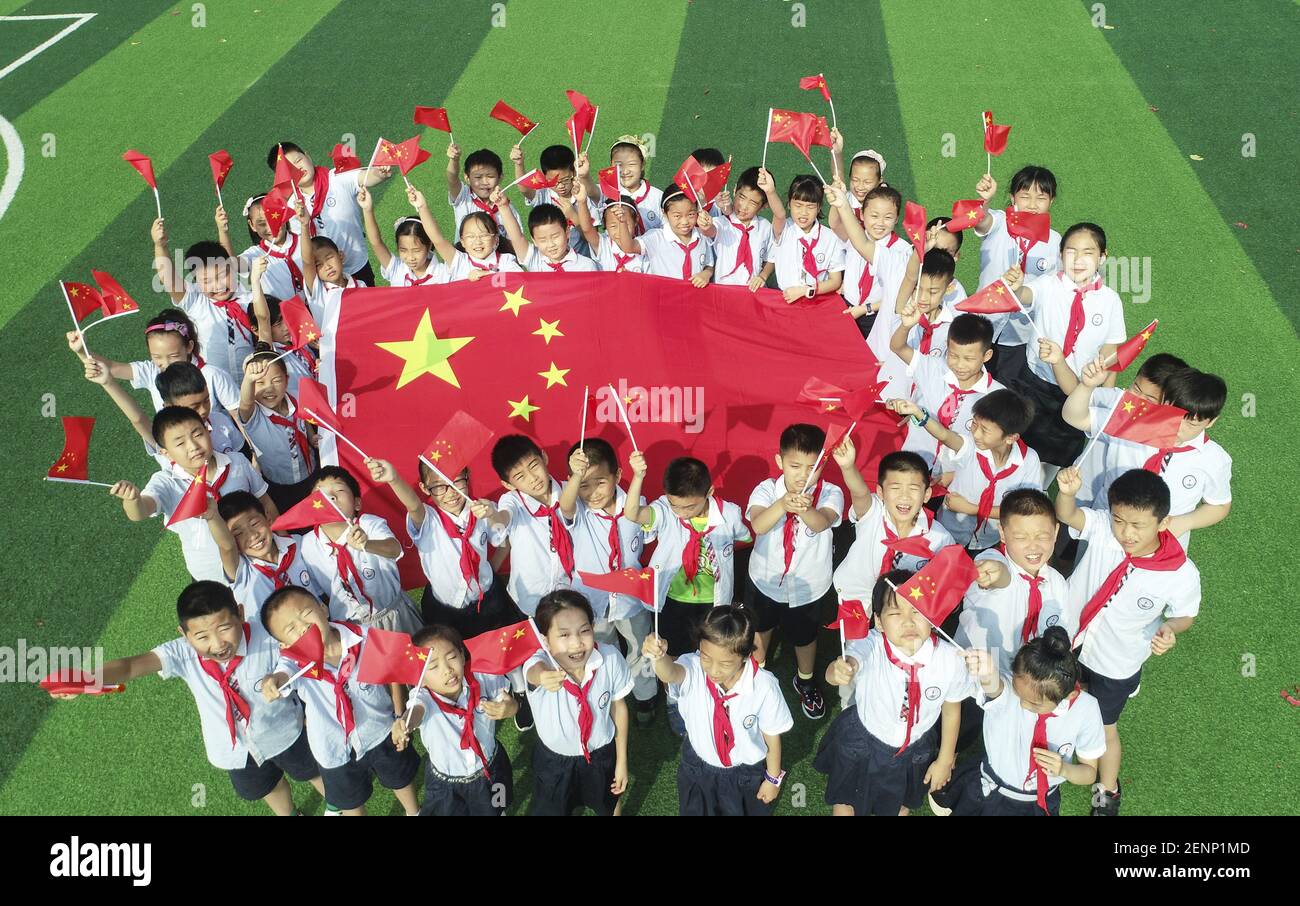 Young Chinese students wave Chinese national flags during a celebration ...