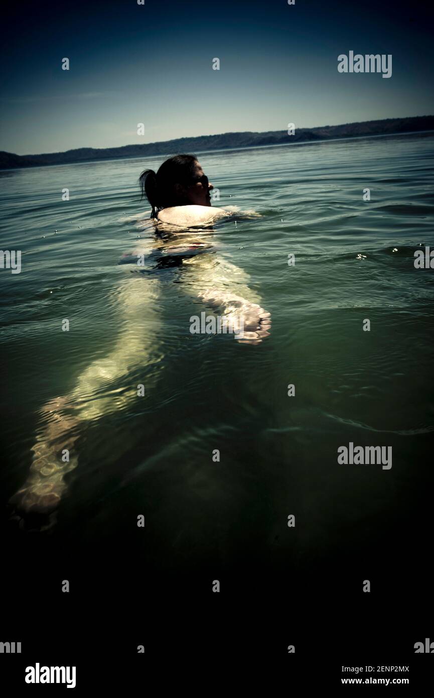 Woman swimming on a beach at Paapgayo Bay in Costa Rica Stock Photo - Alamy