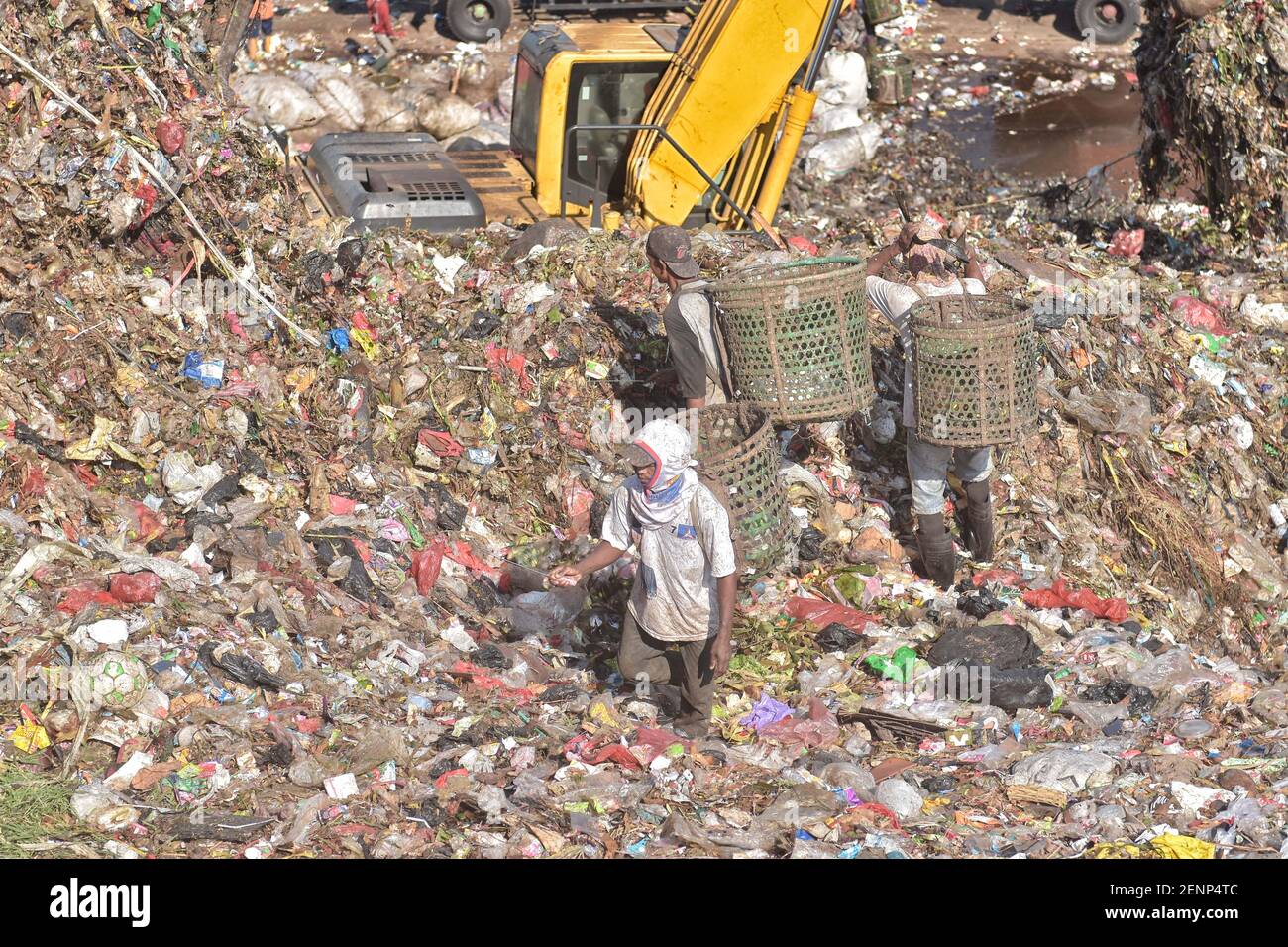 Scavengers sort and collect plastics for recycling at the garbage ...