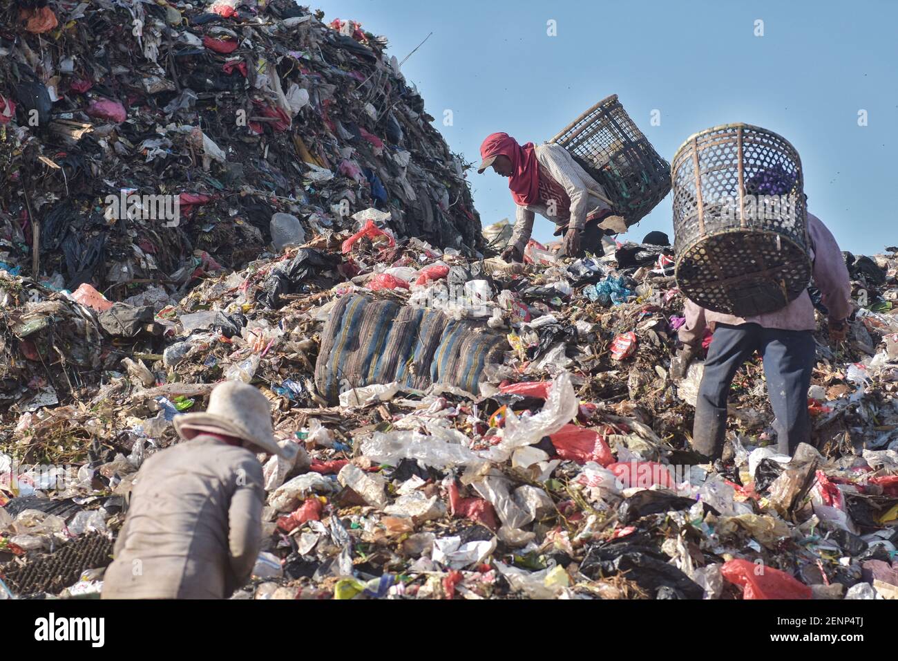 Scavengers sort and collect plastics for recycling at the garbage ...