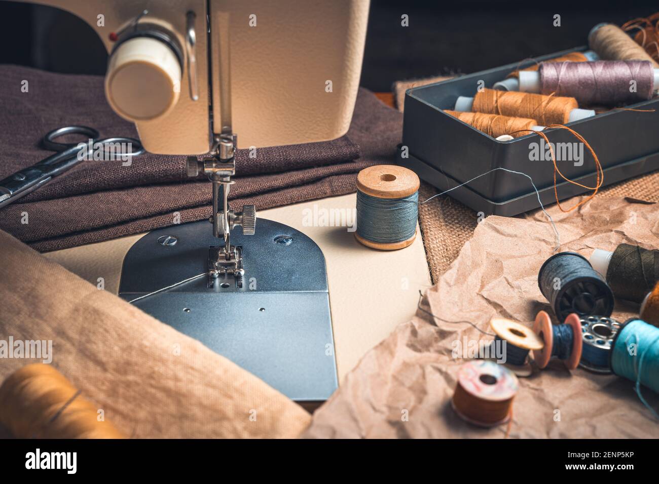 A close-up sewing machine and a set of threads. Side view, vintage ...