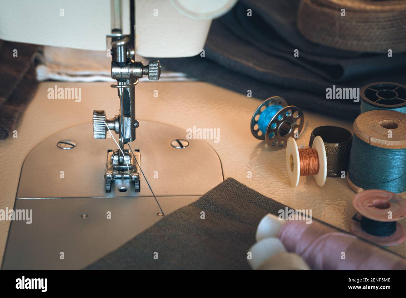 Sewing machine, fabrics and thread. The side view is horizontal. The ...