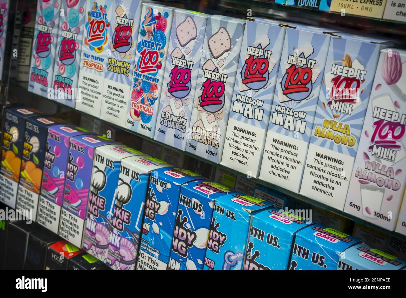 A selection of flavored vaping supplies on display in the window of a ...