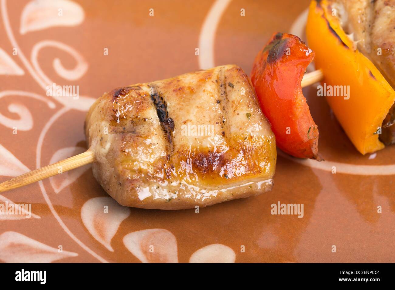 Sturgeon shish kebab with vegetables on a clay plate. Photo can be used ...