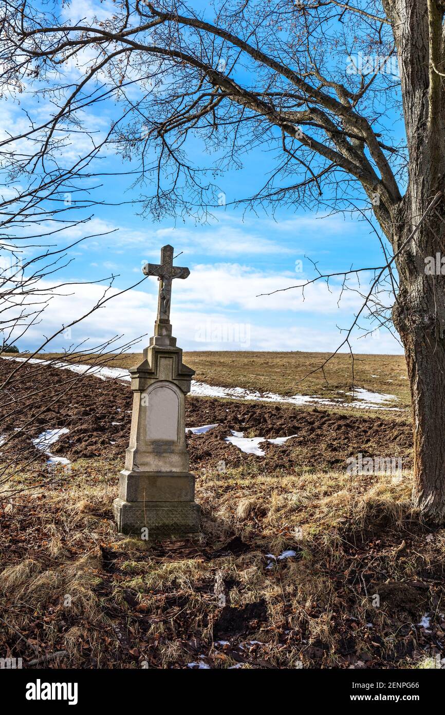Old Christian grey stone cross in Czech Republic. Agricultural ...