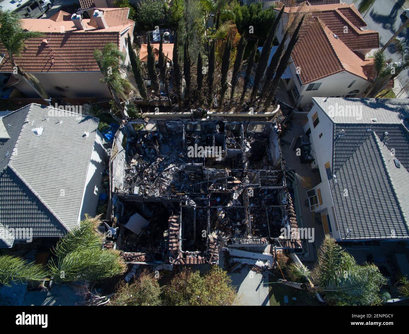 A burned-out house in the middle of a neighborhood Stock Photo - Alamy