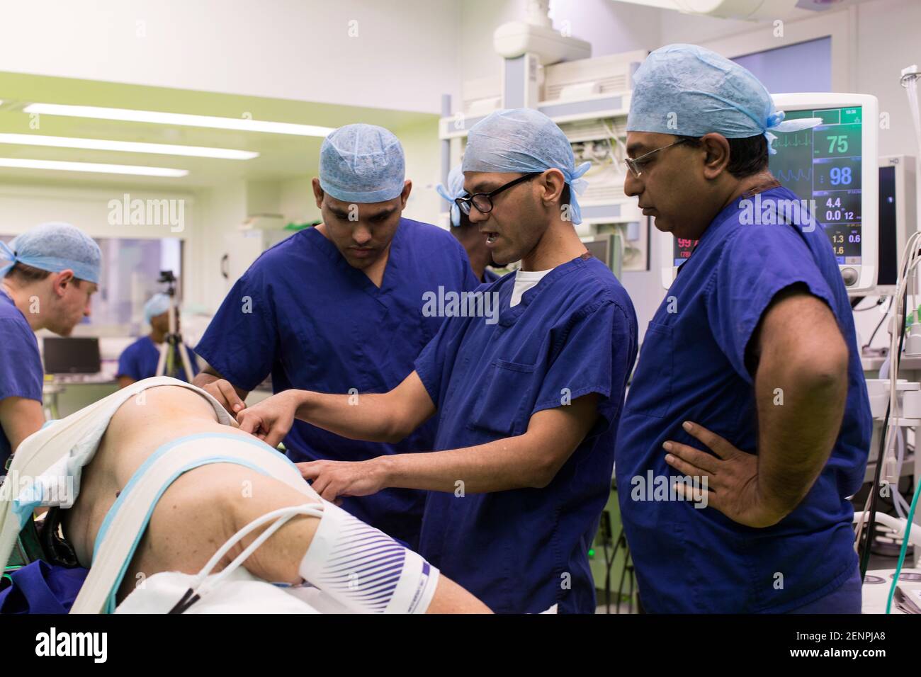 Doctors & Surgeons perform operation Stock Photo - Alamy