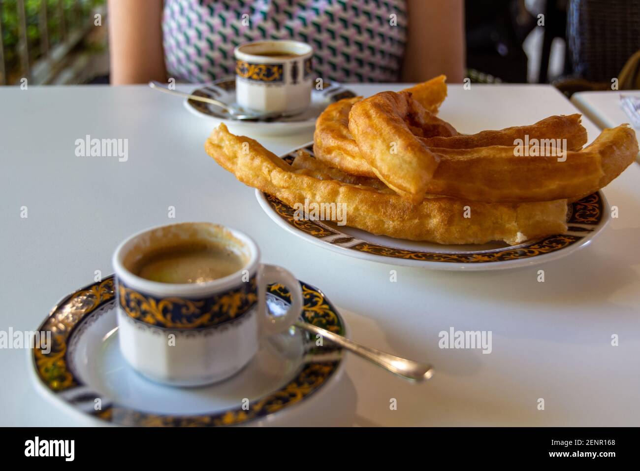Typical breakfast in a cafe in Andalusia: coffee with churros Stock ...
