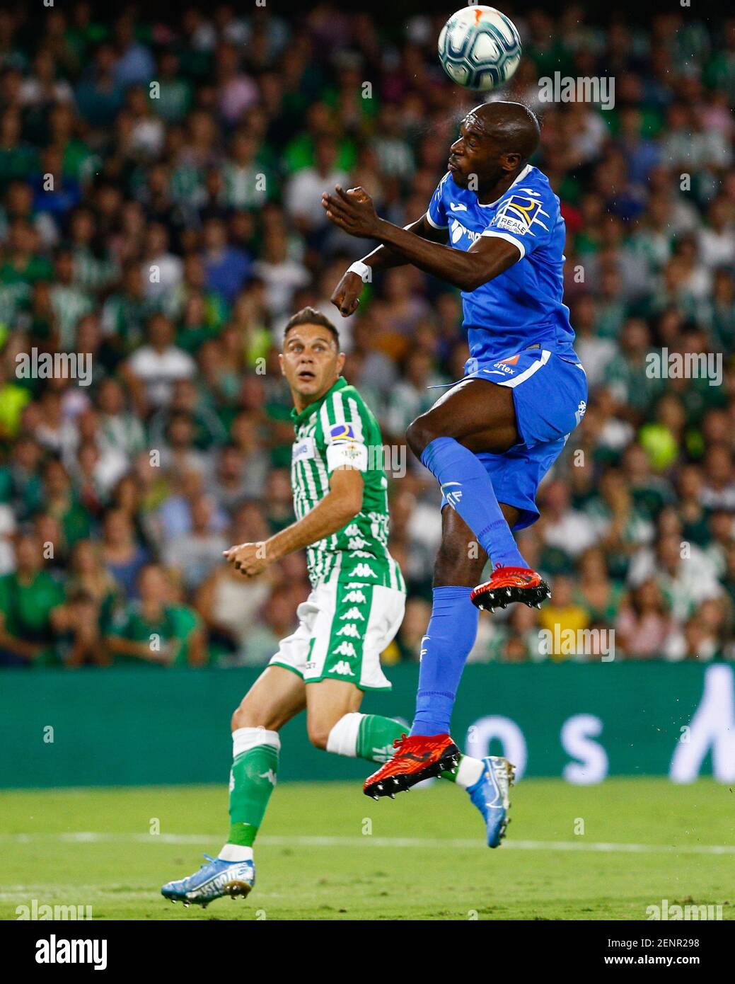 Allan Romeo Nyom of Getafe CF and Joaquin Sanchez of Real Betis during ...