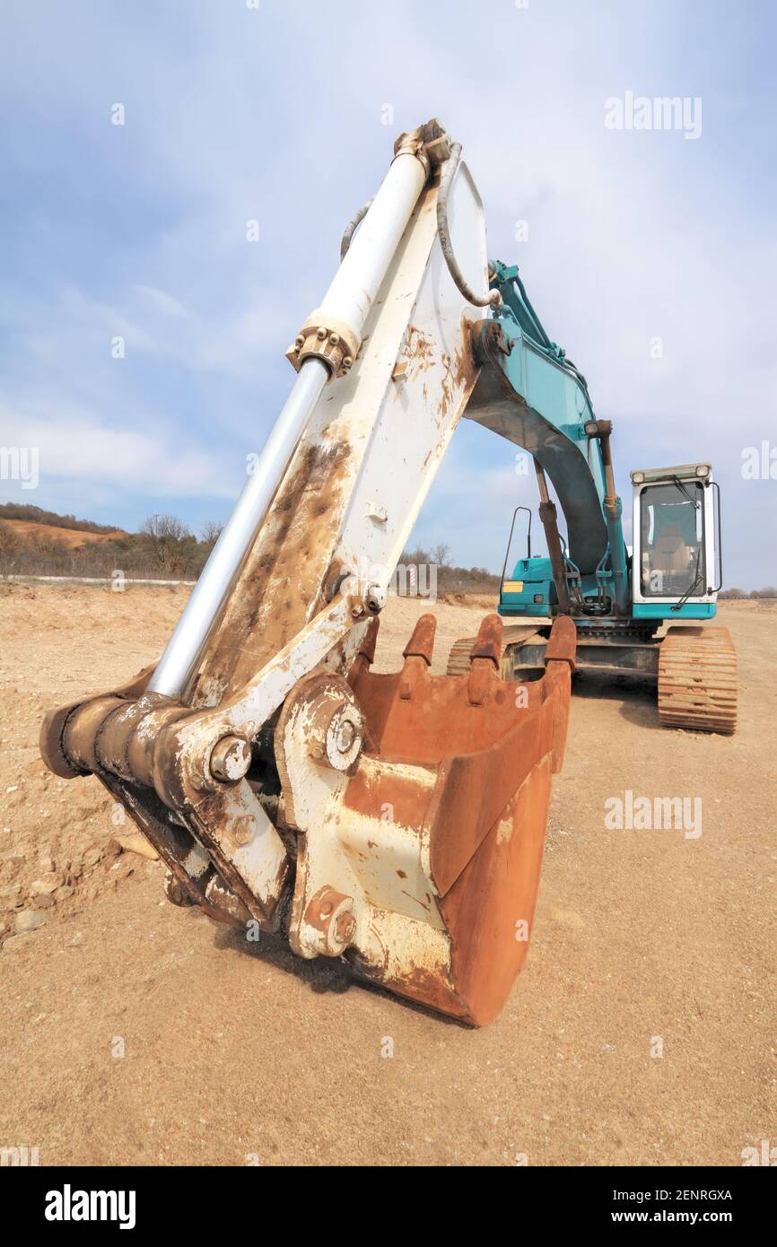 Excavator on road construction site. Wide angle view Stock Photo - Alamy