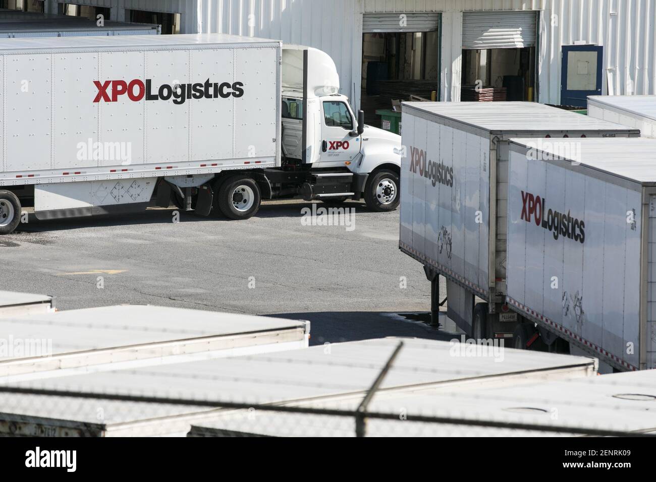 XPO Logistics semi-trailer trucks and trailers at a freight facility in ...
