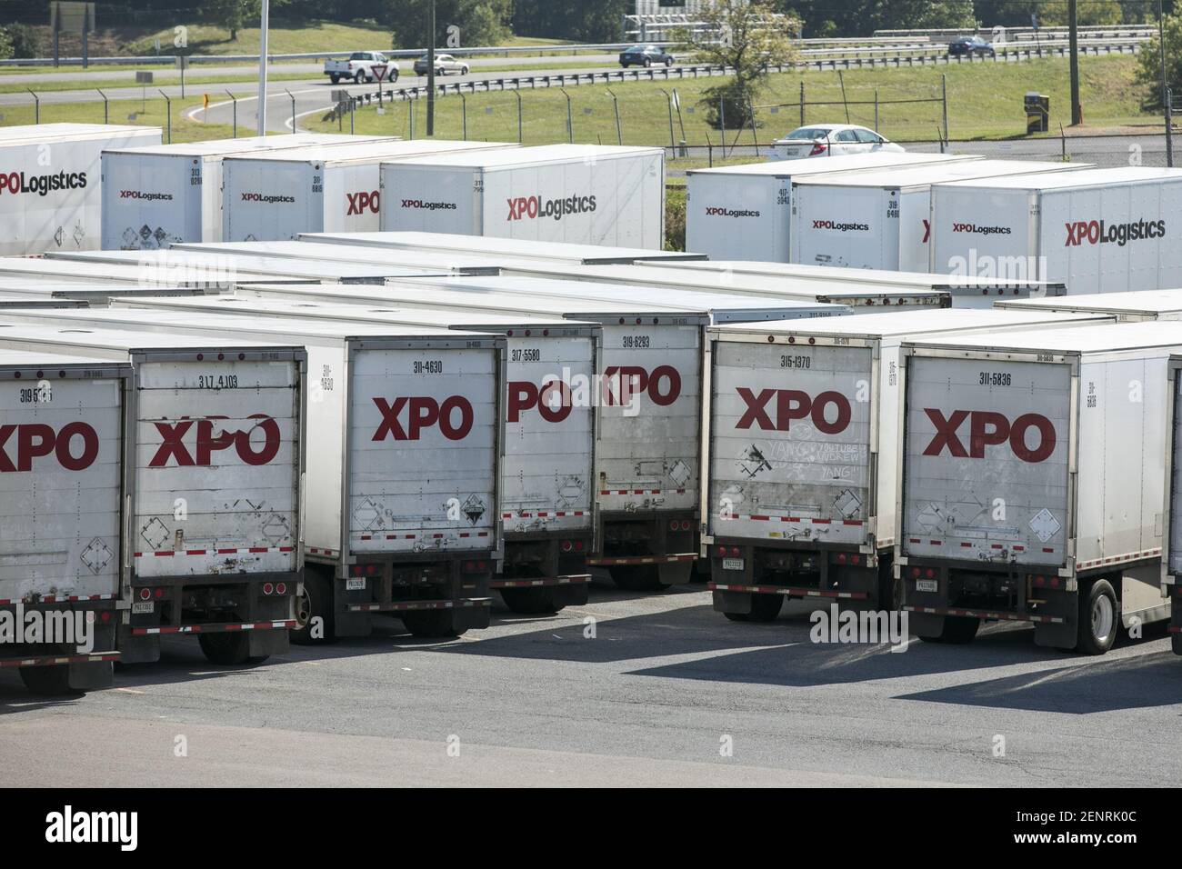 XPO Logistics semi-trailer trucks and trailers at a freight facility in ...