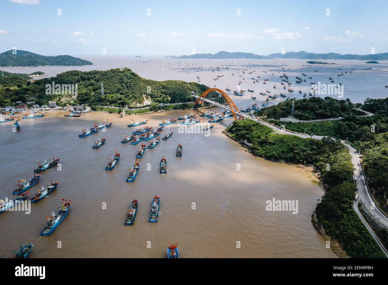 An aerial view of thousands of fishing boats heading towards the ocean ...