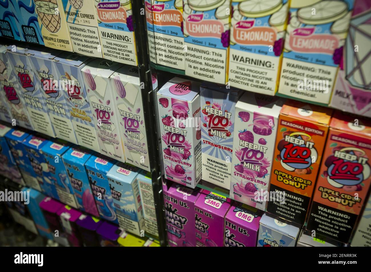 A selection of flavored vaping supplies on display in the window of a ...