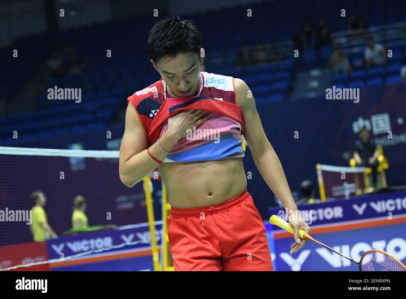 Japanese professional badminton player Kento Momota competes against ...