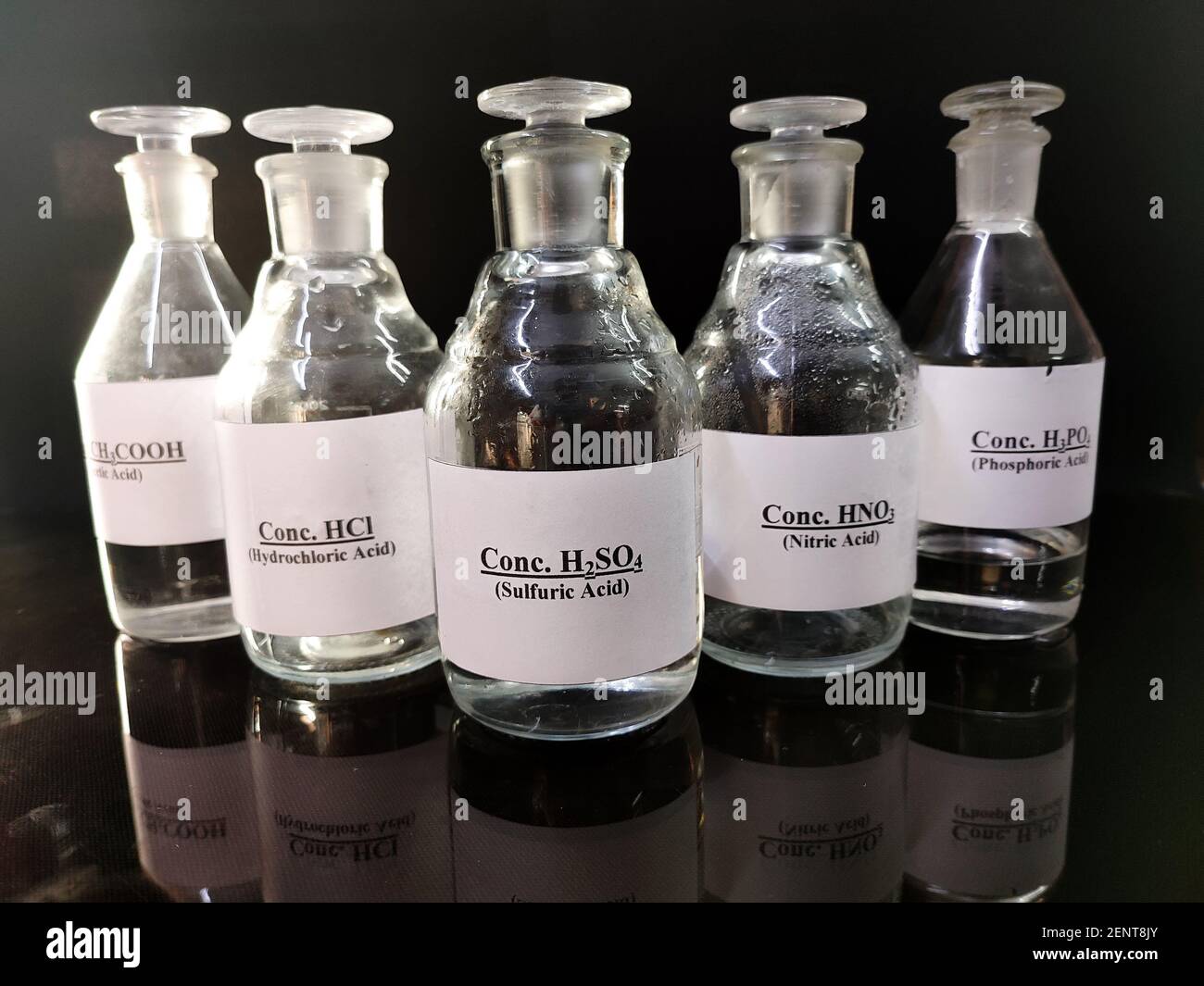 transparent bottles filled with concentrated acid Stock Photo - Alamy