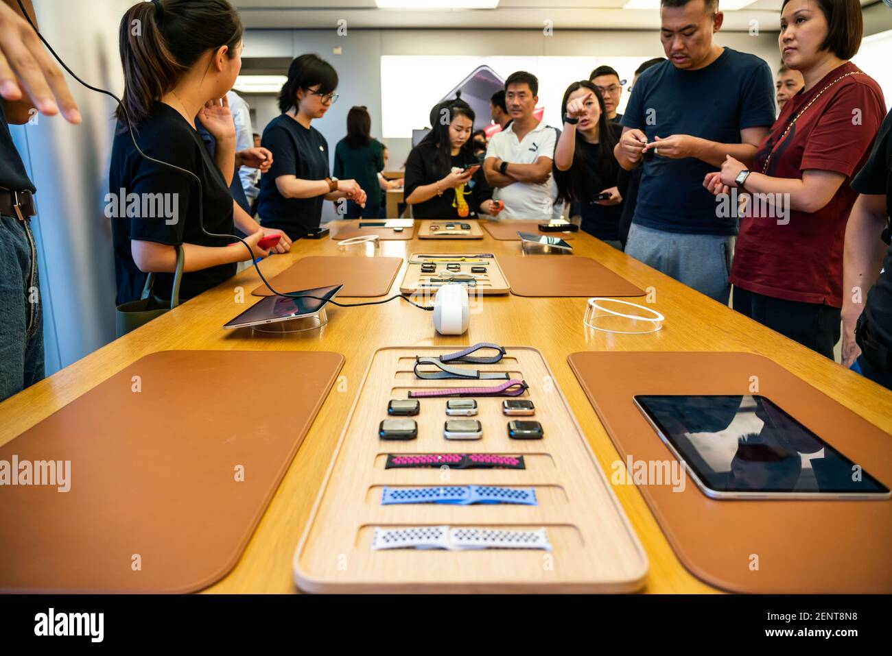 Customers look at Apple's new iPhone 11 series smartphones at an Apple ...