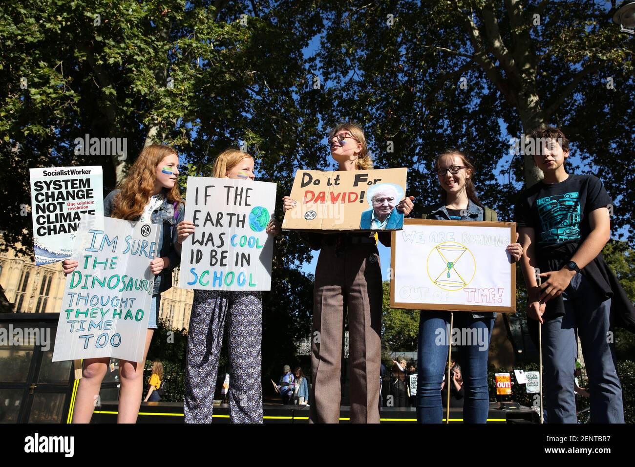Protesters hold placards while shouting slogans during the ...