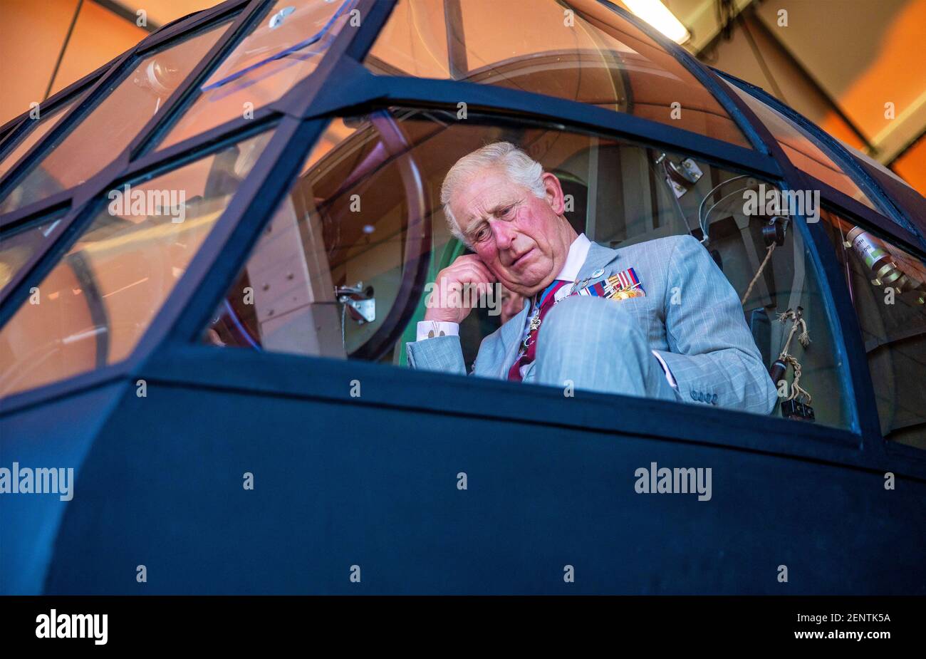 Prince Charles sits in the cockpit of a replication slider and poses ...