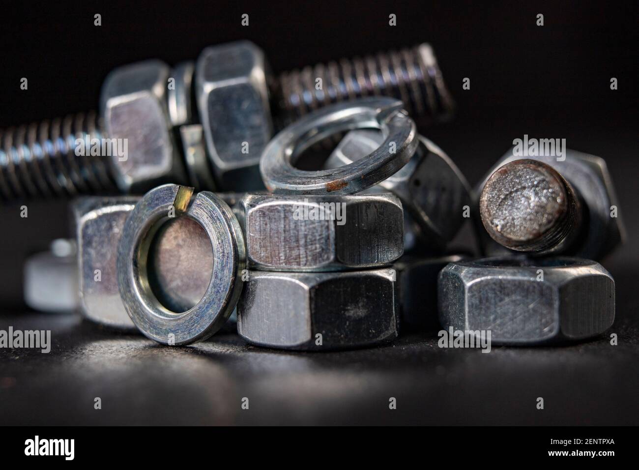 Metal screws and washers on a dark table. Accessories for mounting ...