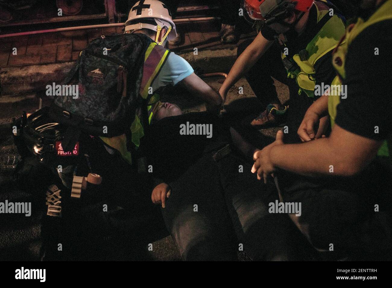 Paramedics help a fainted demonstrator during the protests. Protesters ...