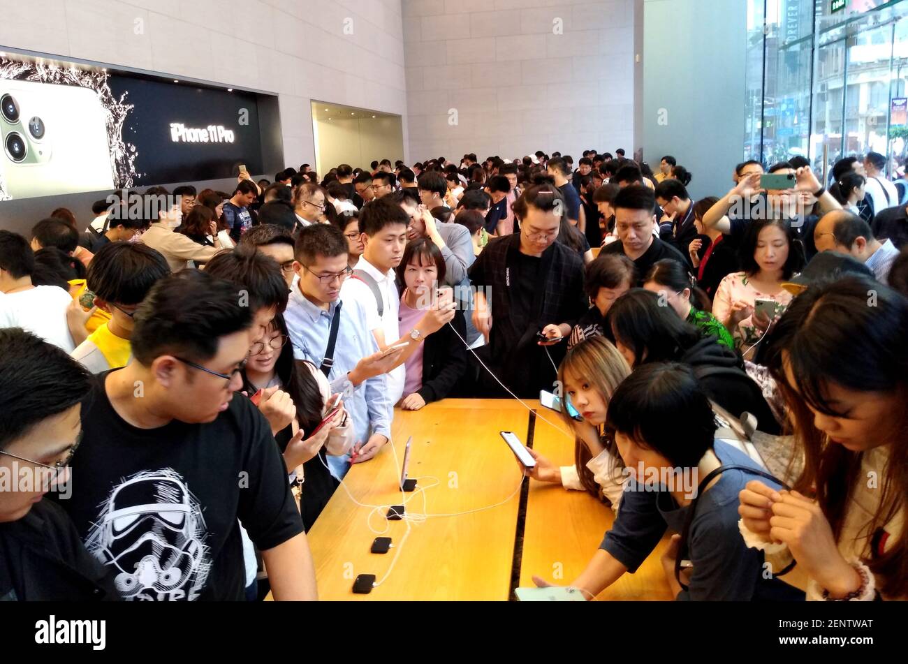 The Apple retail store is crowded with fans waiting to experience the ...