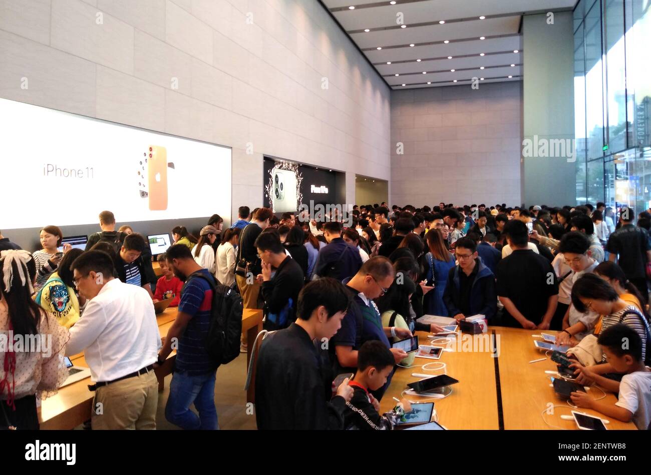 The Apple retail store is crowded with fans waiting to experience the ...