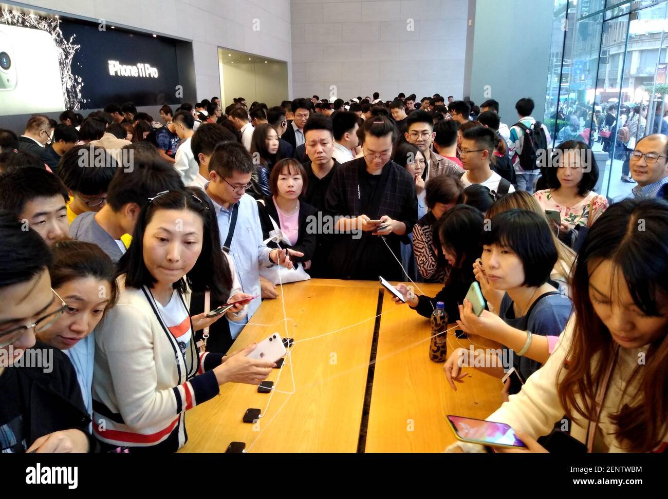 The Apple retail store is crowded with fans waiting to experience the ...