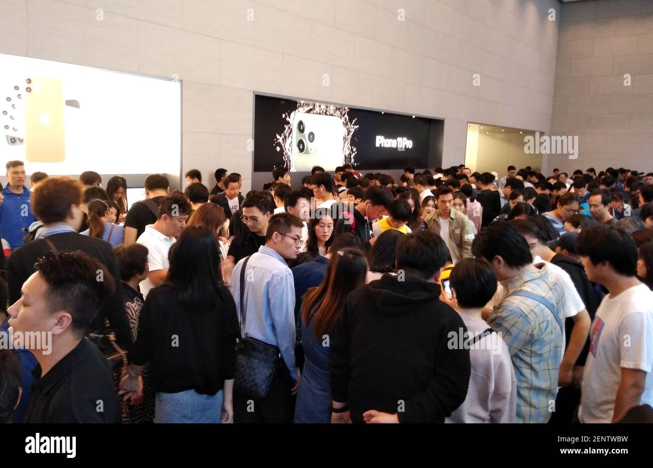 The Apple retail store is crowded with fans waiting to experience the ...