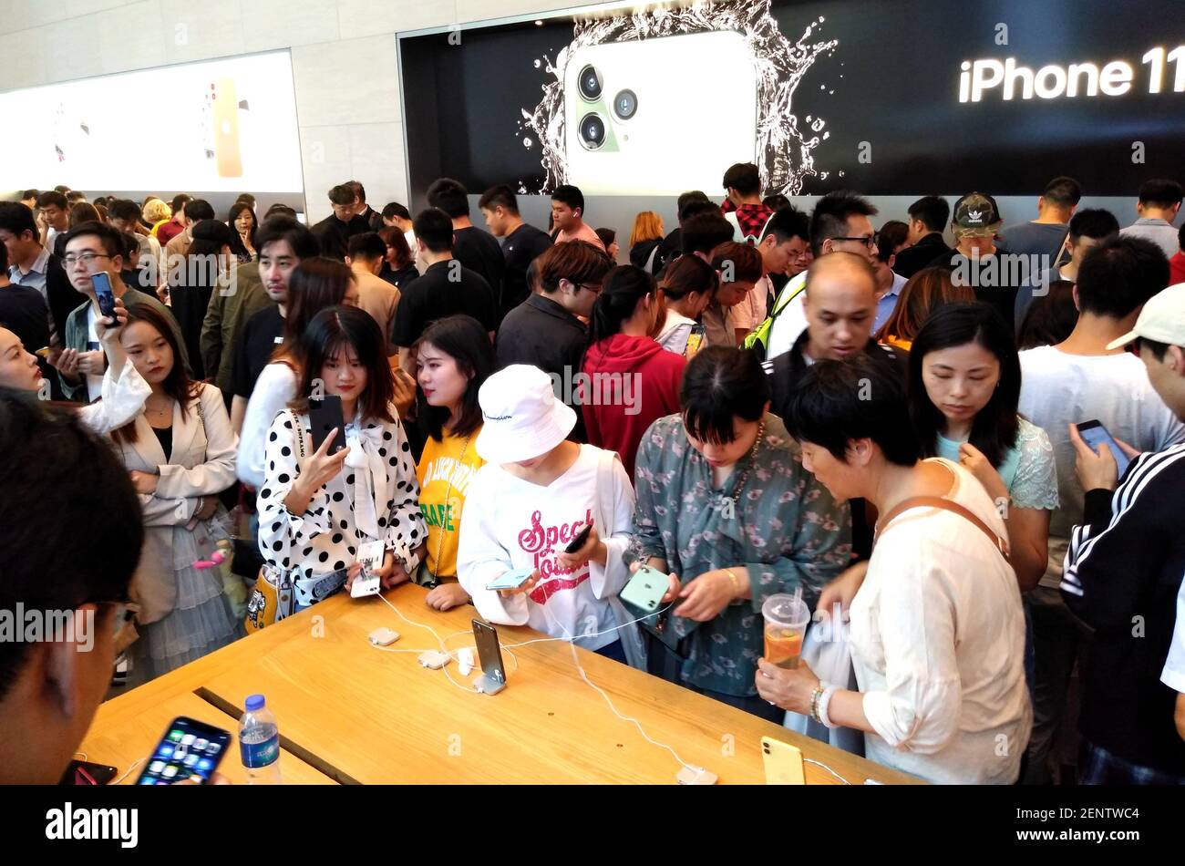 The Apple retail store is crowded with fans waiting to experience the ...