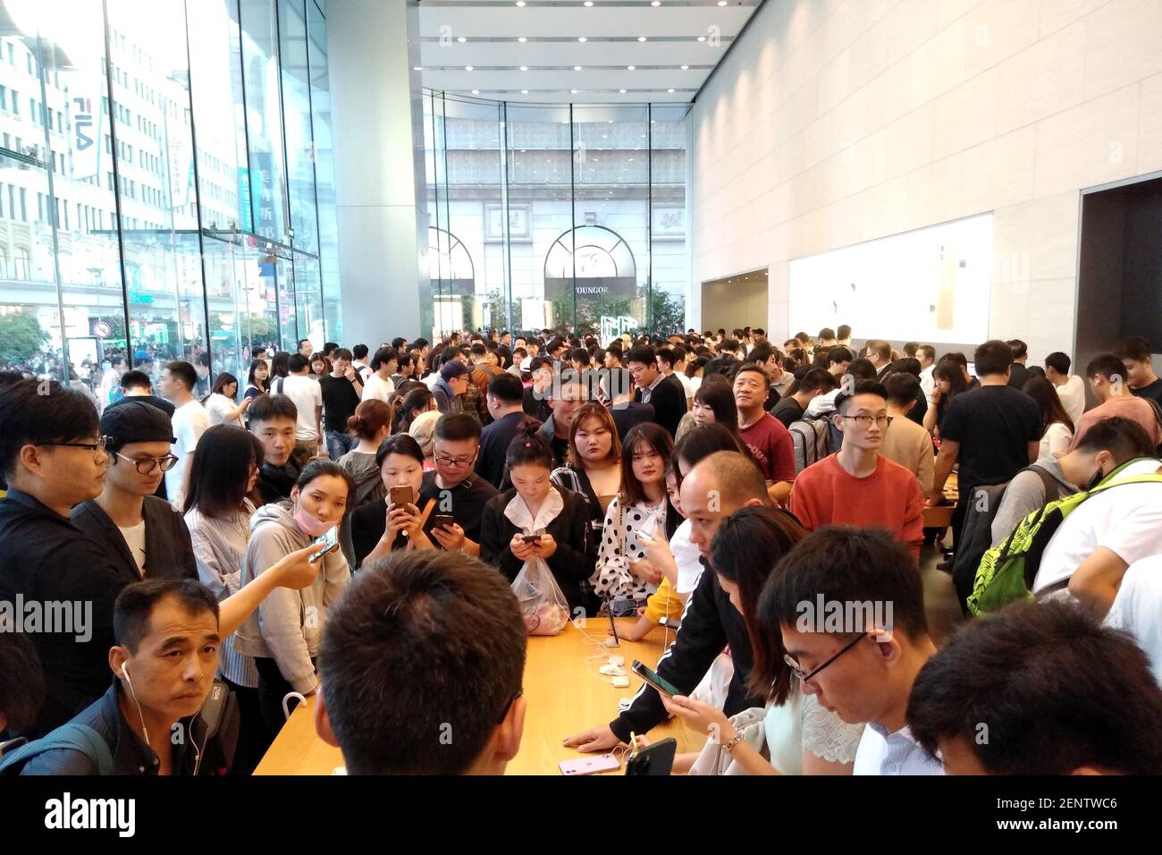 The Apple retail store is crowded with fans waiting to experience the ...