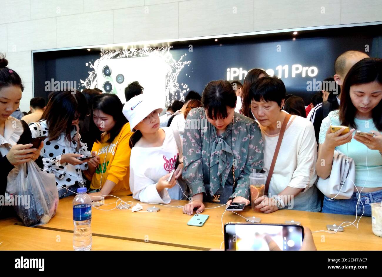 The Apple retail store is crowded with fans waiting to experience the ...