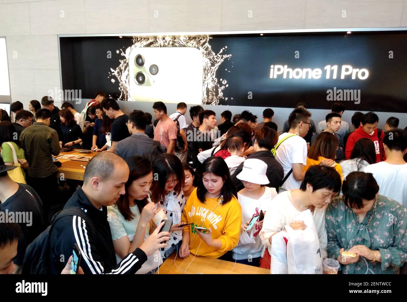 The Apple retail store is crowded with fans waiting to experience the ...