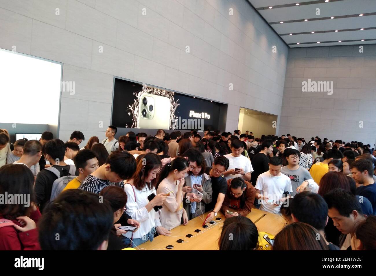 The Apple retail store is crowded with fans waiting to experience the ...