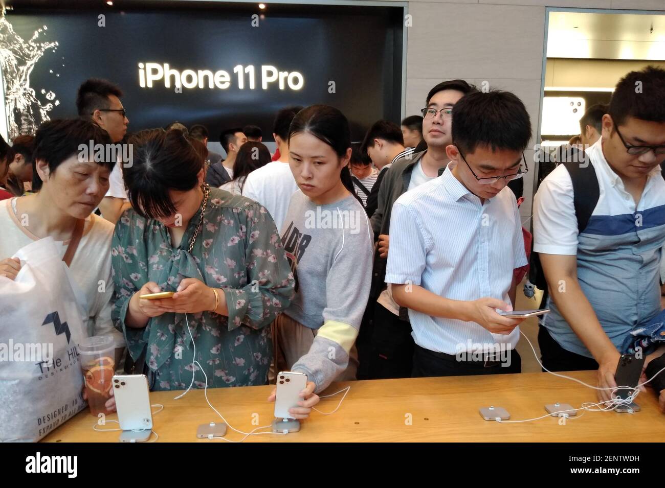 The Apple retail store is crowded with fans waiting to experience the ...