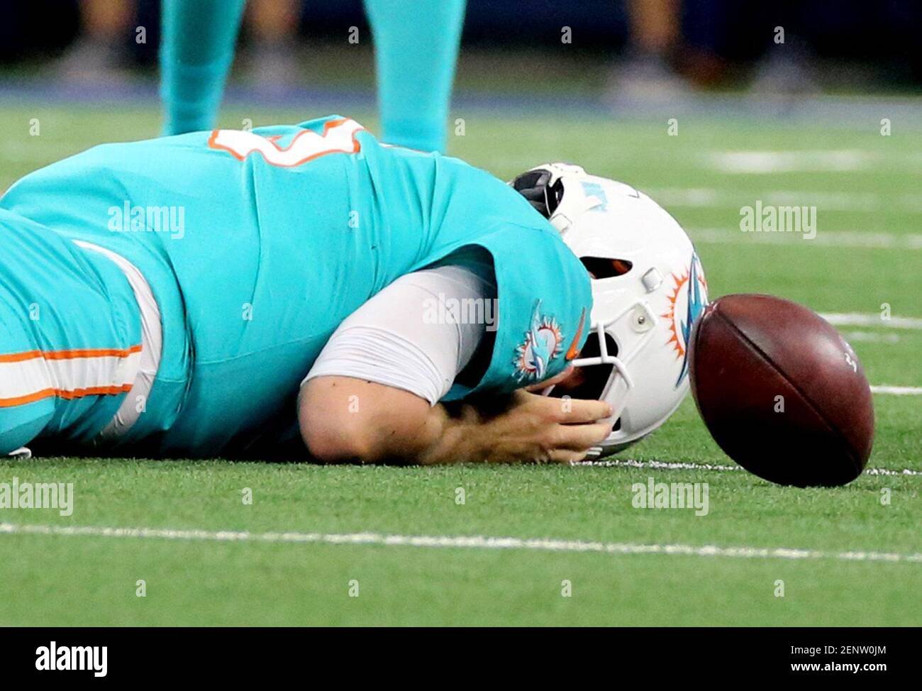 Miami Dolphins quarterback Josh Rosen (3) holds his face after he hit ...