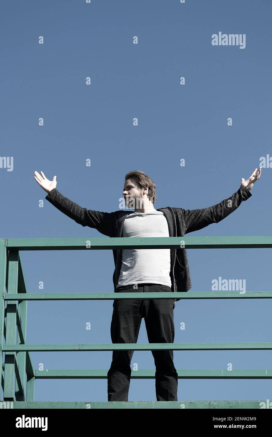 Man with open hand gesture stand on height on sunny blue sky. Freedom ...