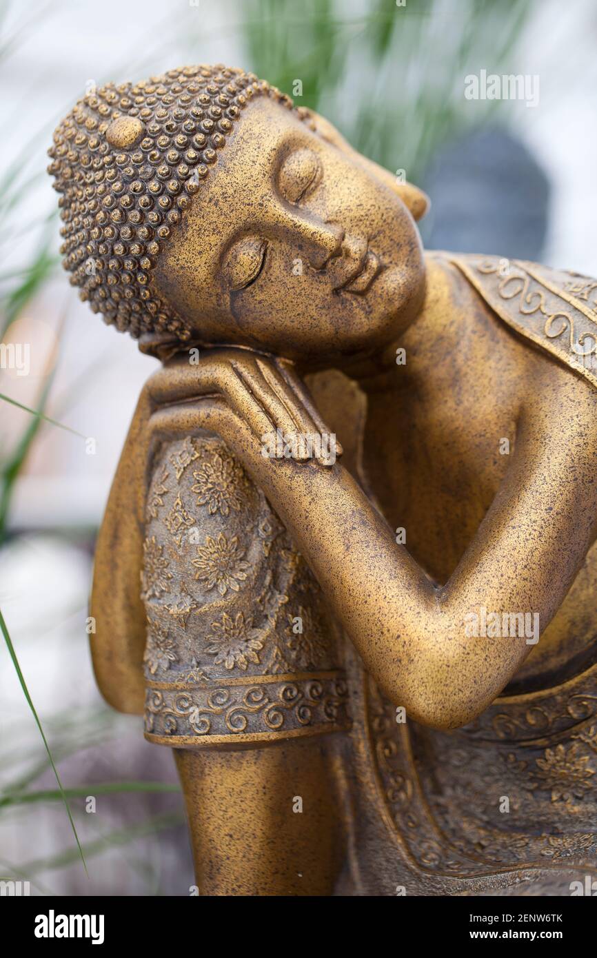 Small golden metal buddha figurine Stock Photo - Alamy