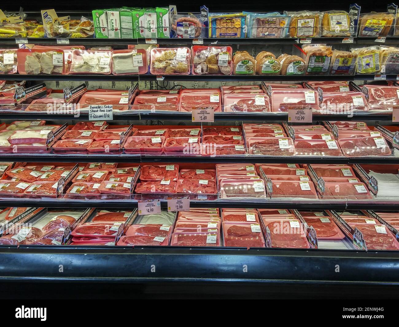An attractive display of meat in the butcher department of a ...