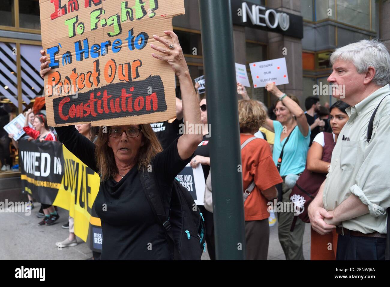 Protesters holds a placard during the Rise and Resist - United in ...