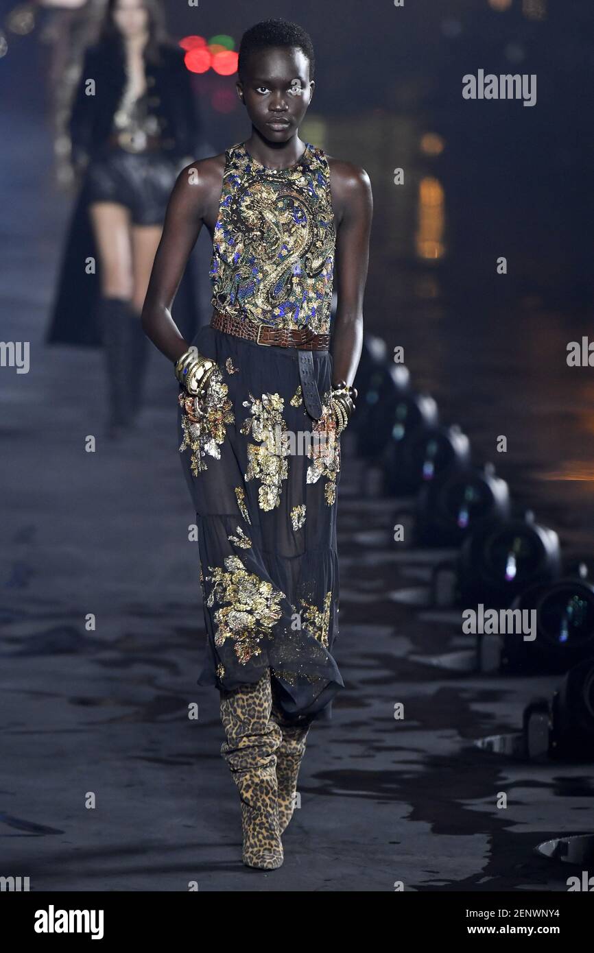 Model Achenrin Madit walking on the runway during the Yves Saint ...