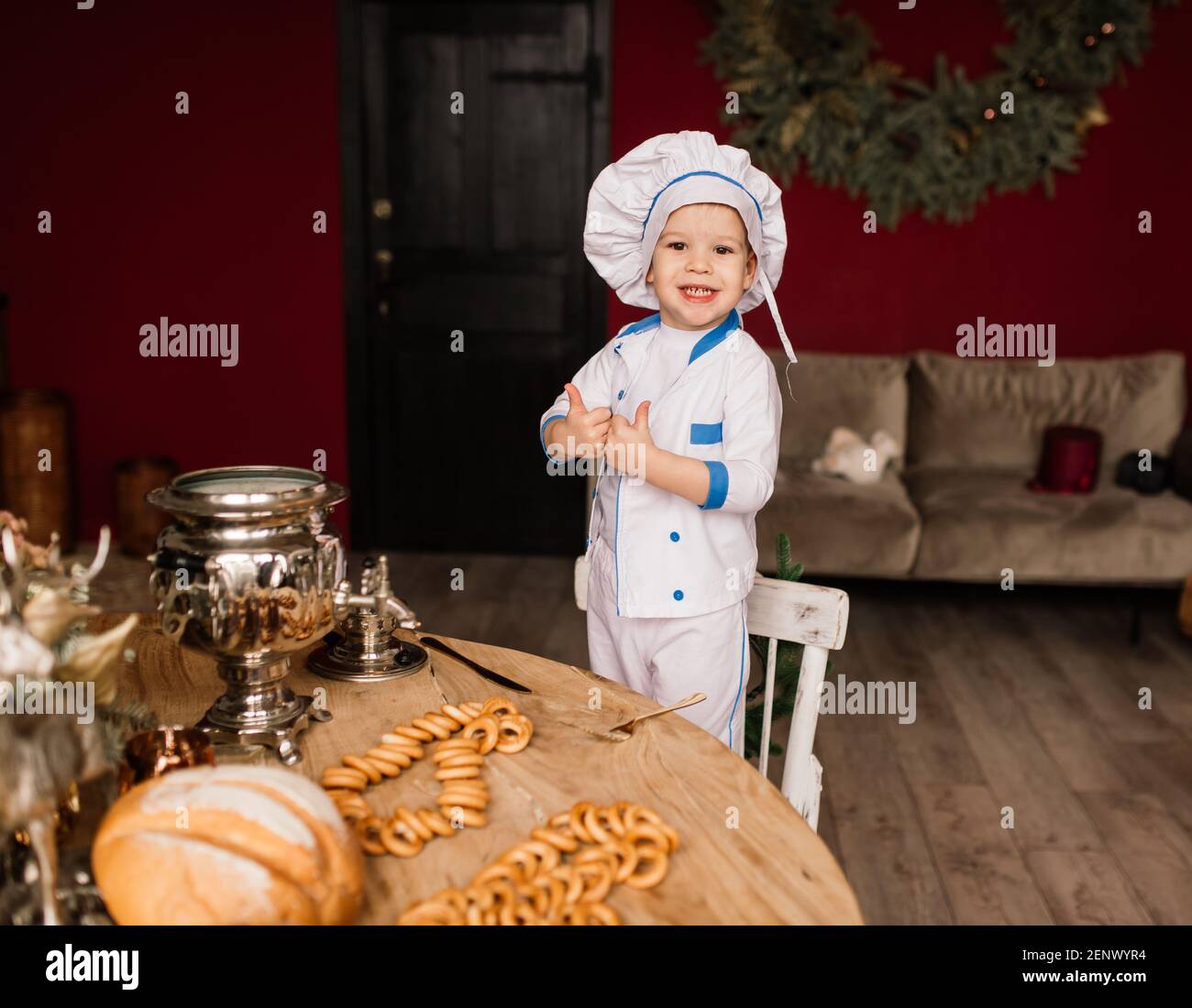 Healthy eating concept. Happy little boy is cooking in kitchen on a ...