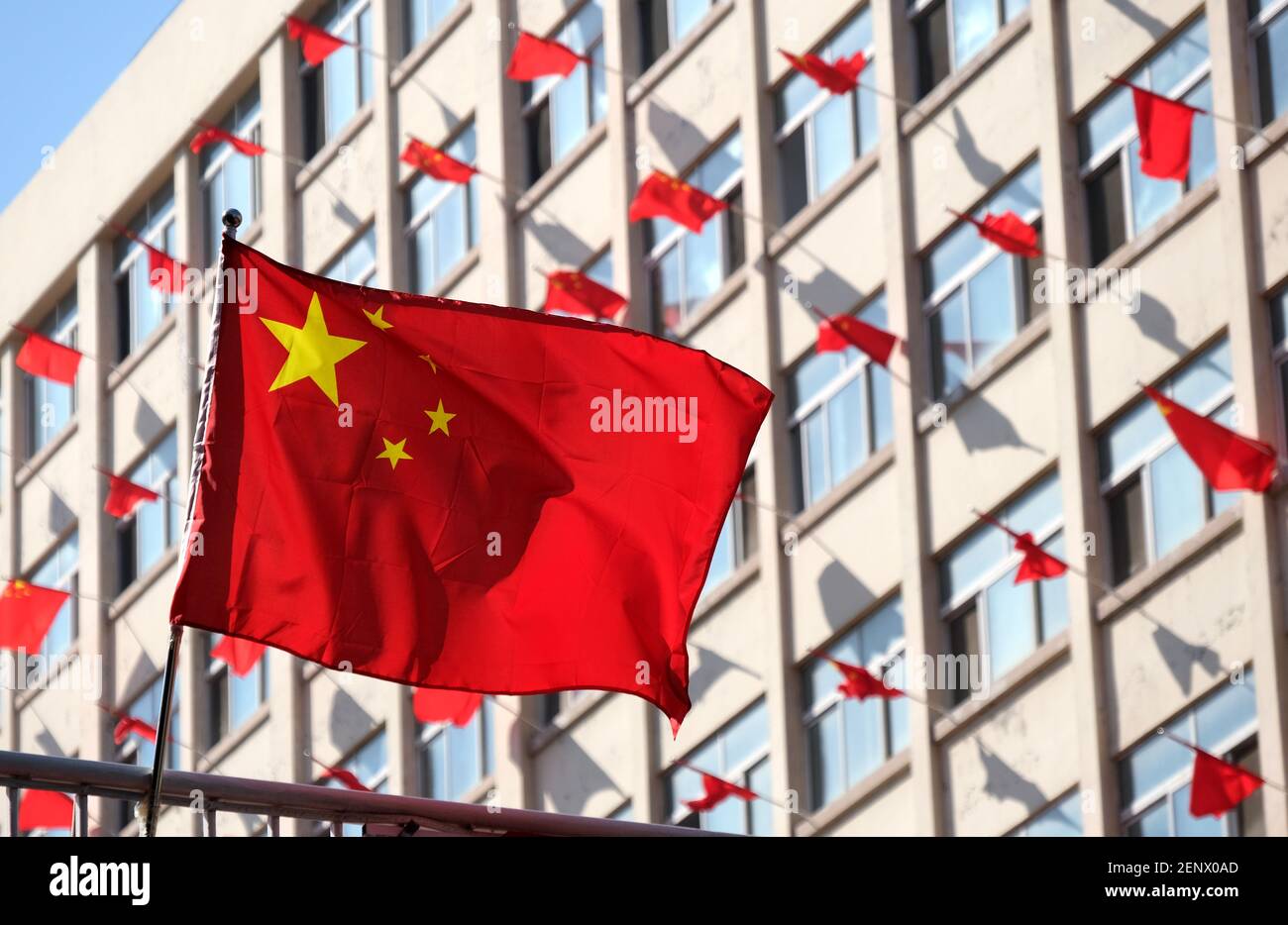 Chinese national flags flutter on the windows at the campus of Liaoning ...