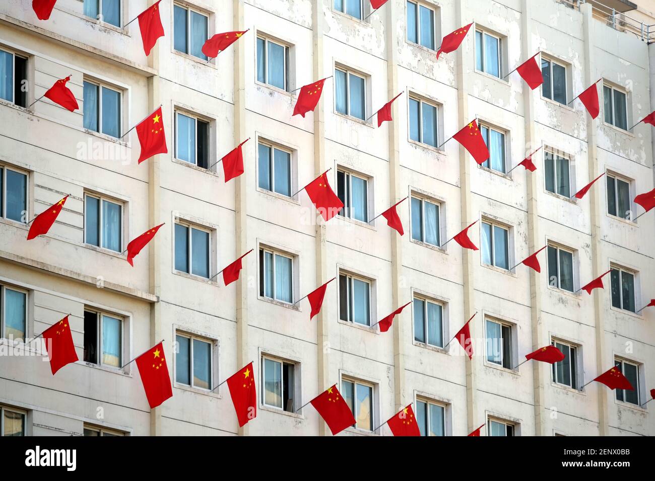 Chinese national flags flutter on the windows at the campus of Liaoning ...